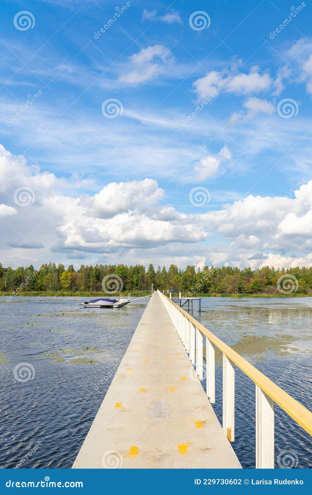 A Long White Pier on the River with a Railing on One Side Stock Photo ...