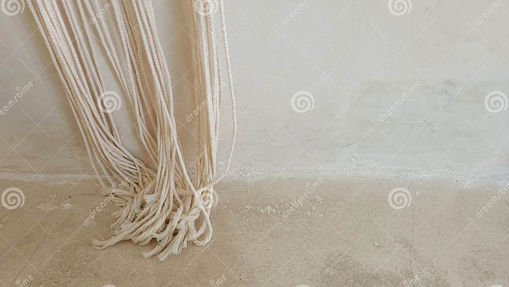 A Long White Rope is Hanging from the Wall Stock Photo - Image of brown ...