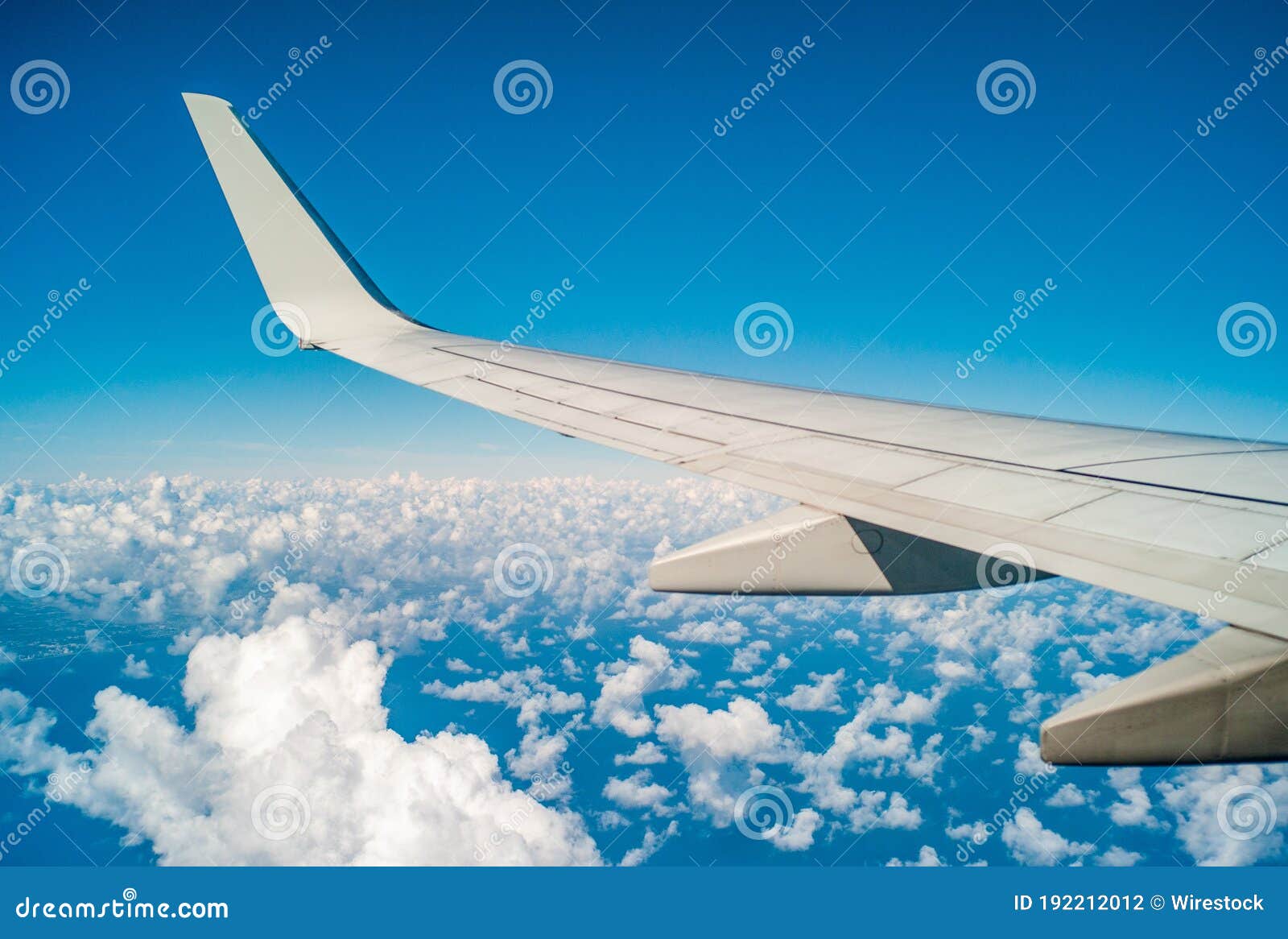 Long Wing of the Airplane in the Blue Cloudy Sky Stock Photo - Image of ...