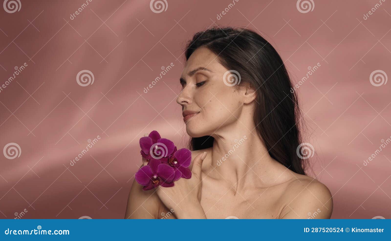 The Longhaired Brunette Woman Tenjoys The Velvety Of Her Skin As She