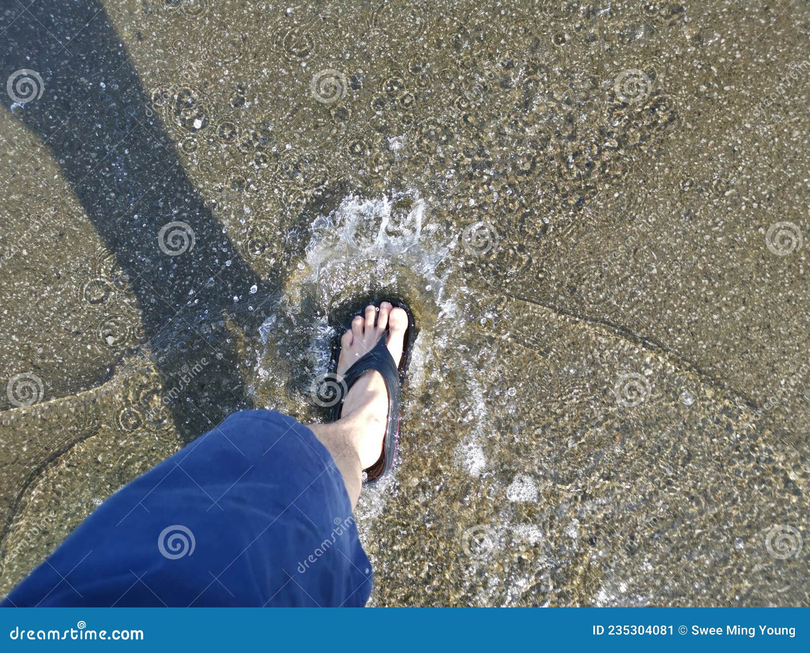 Look Down View of Foot Stepping Onto the Puddle Stock Image - Image of ...