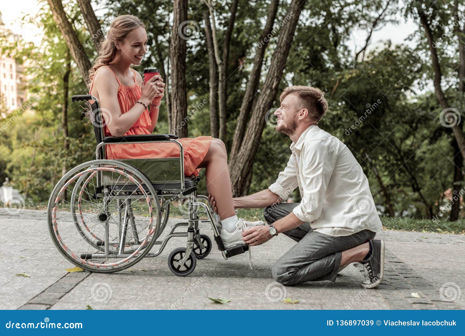 Positive Delighted Bearded Man Helping His Girlfriend Stock Image