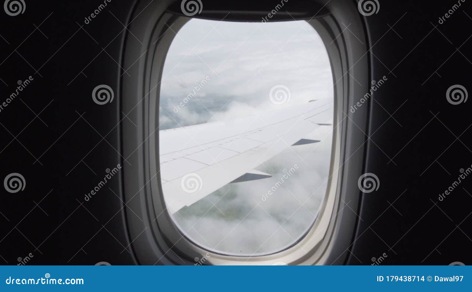 Look Outside of Airplane Window Onto Moving Clouds with View on Wing ...