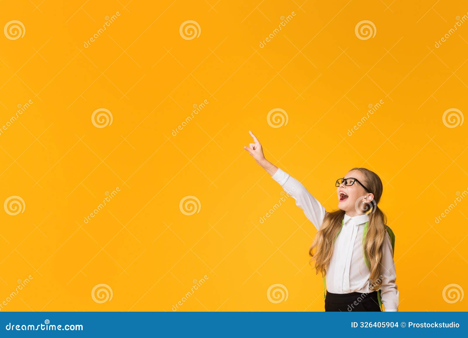 Elementary School Girl Pointing Finger Posing Over Yellow Studio ...