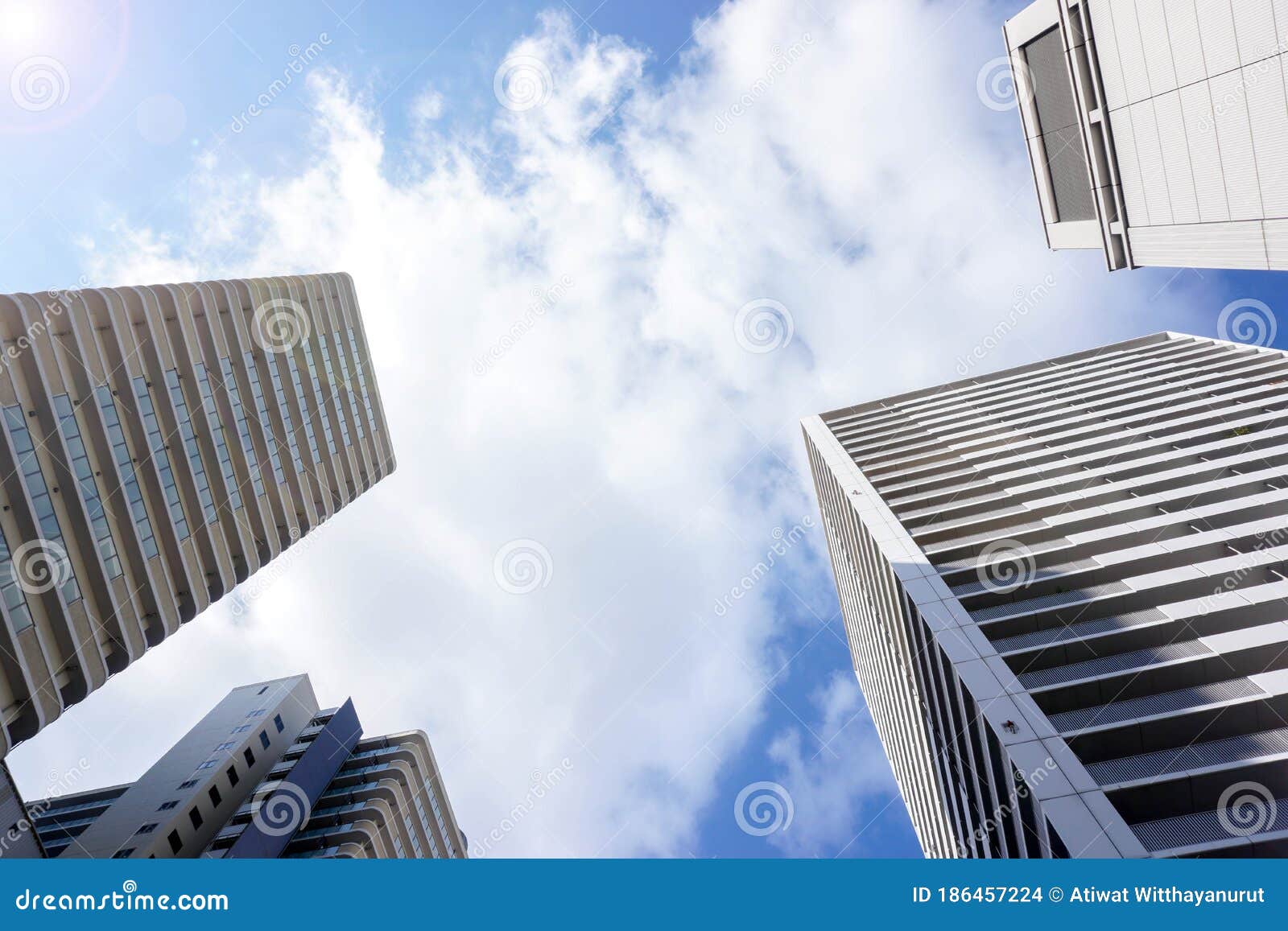 Look Up View and Crop of Office Building on Bright Blue Sky Background ...