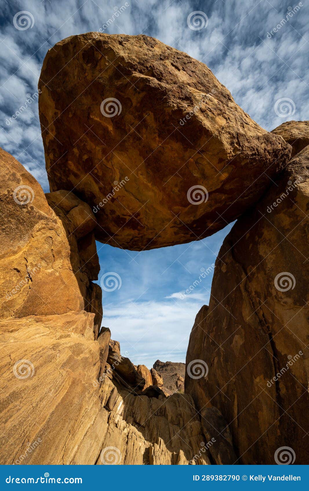 Looking through Balanced Rock with Clouds Streaking Overhead Stock ...