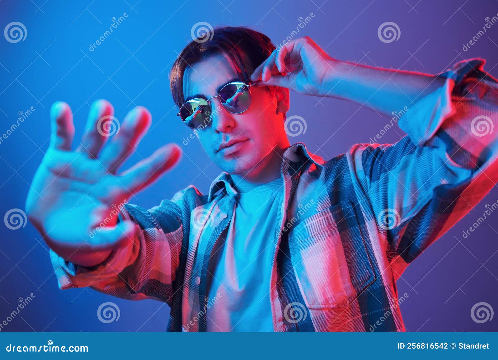 Looking into Camera. Man Standing in the Studio with Neon Light Stock ...