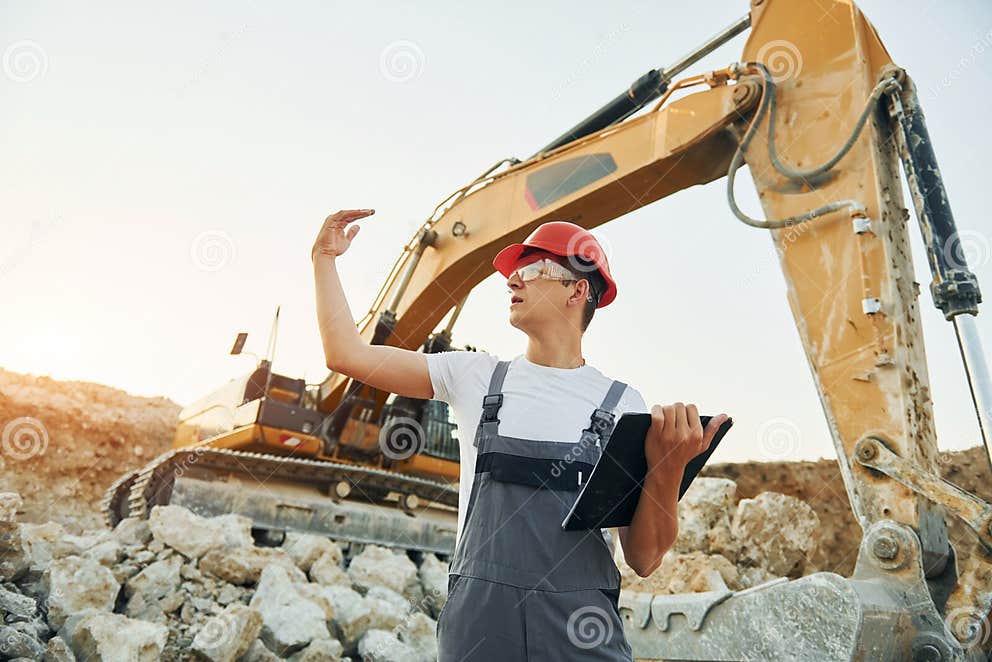 Looking at Distant Object. Worker in Professional Uniform is on the ...