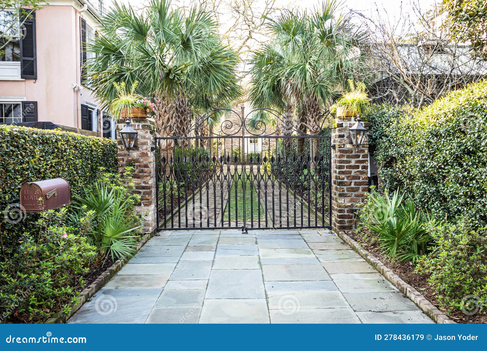 Looking Down a Alley with a Stone Surface and a Security Gate Stock ...