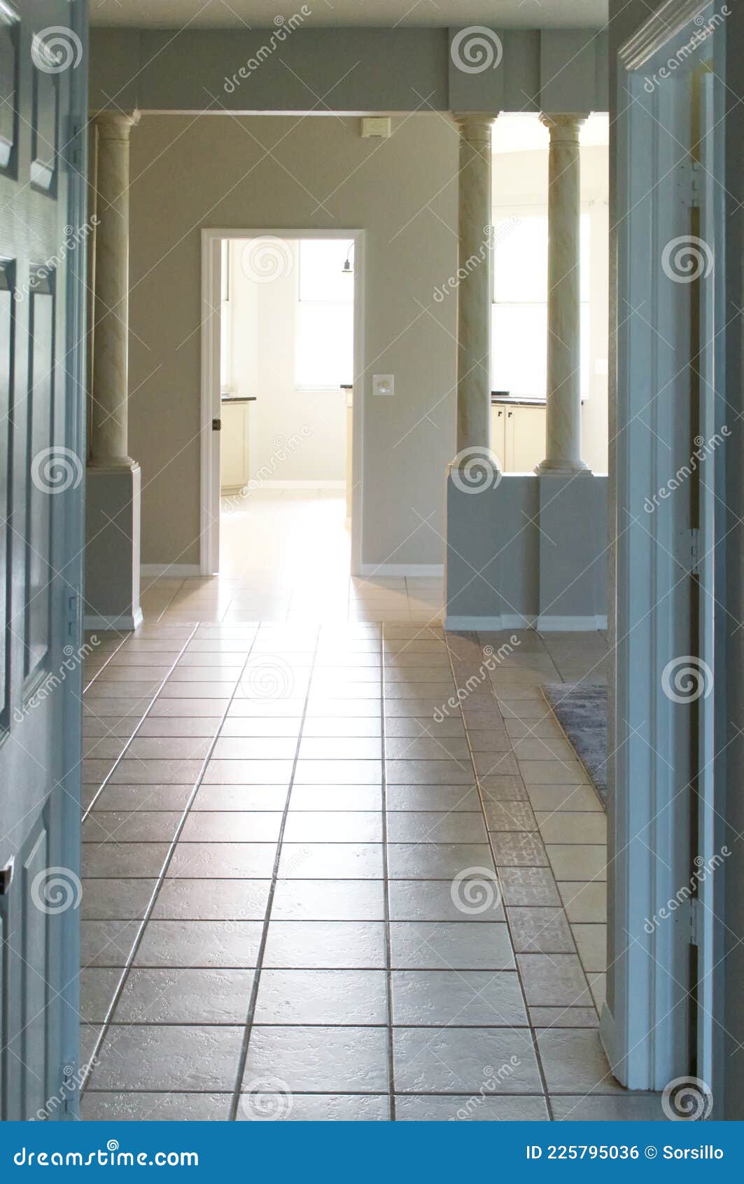 Looking Down Hallway To Brightly Lit Room with Columns Stock Photo ...