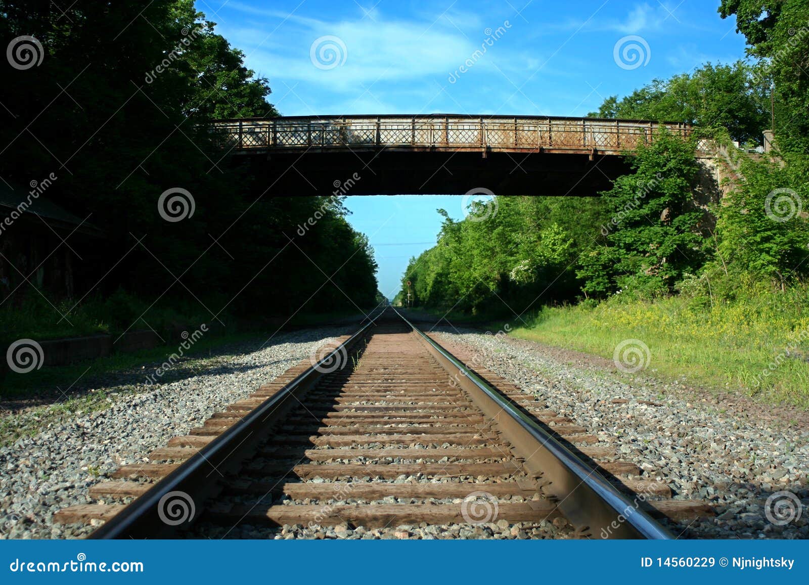 Looking Down Railroad Tracks with Bridge Stock Image - Image of blue ...