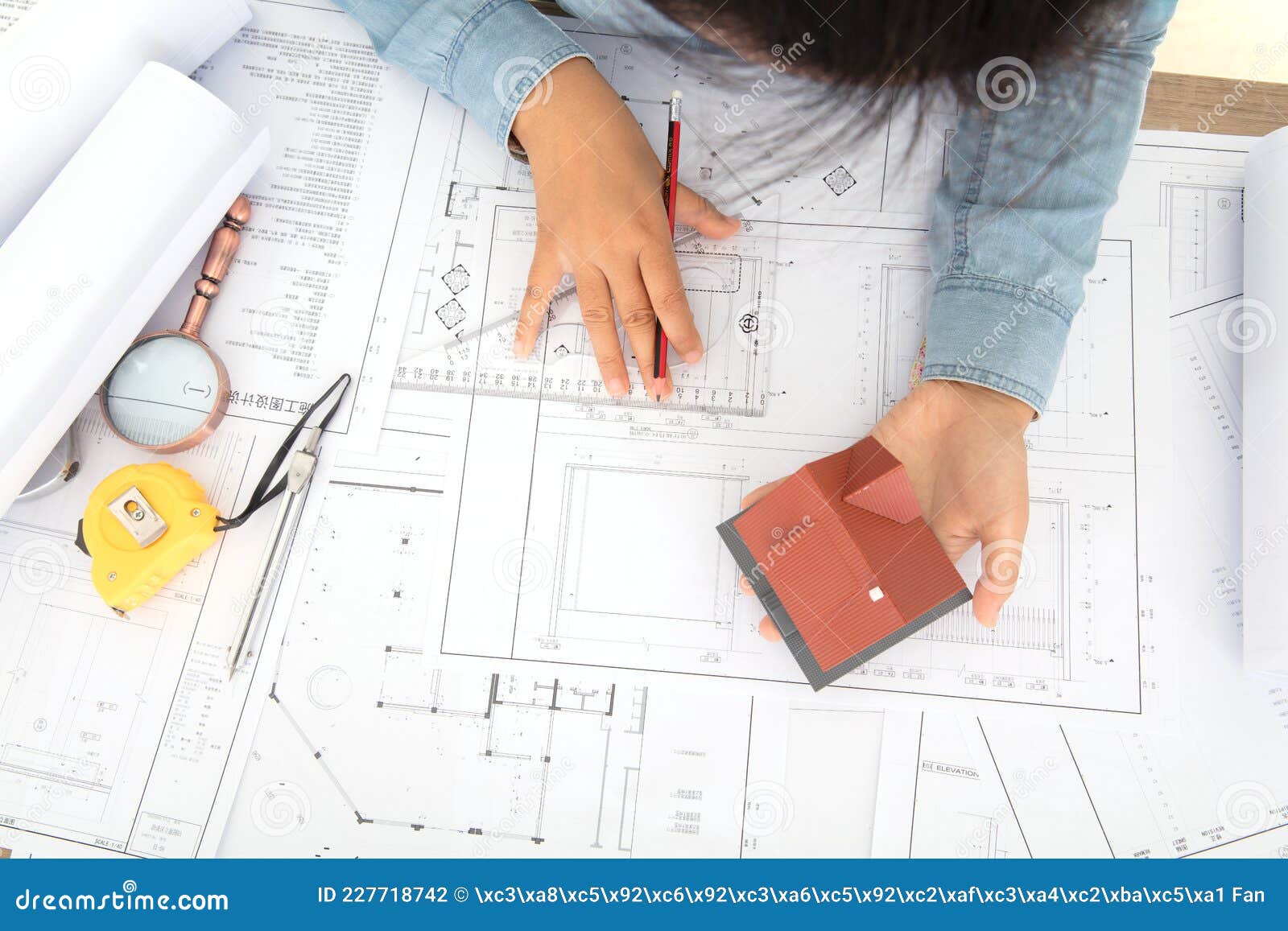 Looking Down and Shooting, the Hard-working Architect is Holding a ...