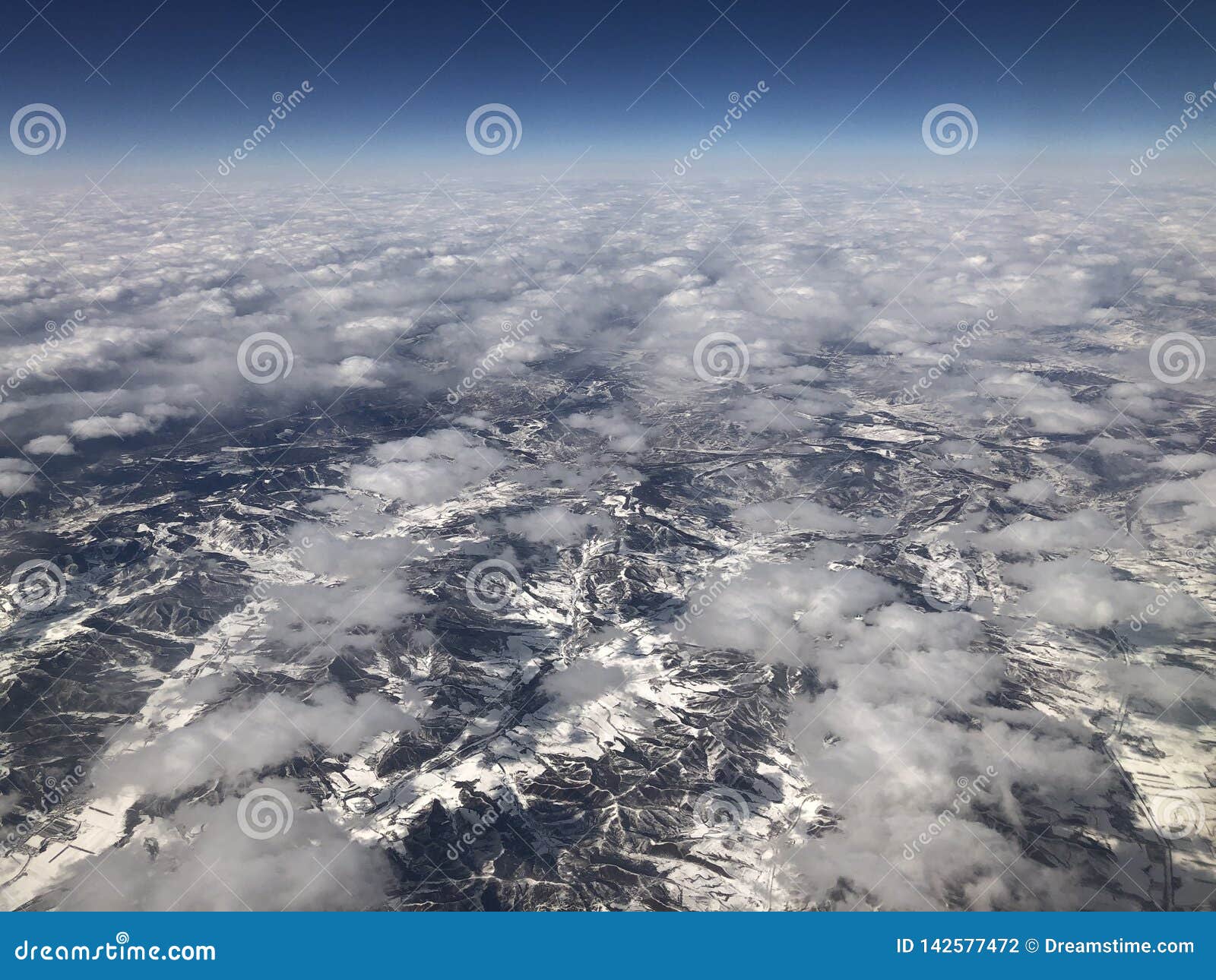 Looking Down from the Sky, the Earth Covered with Snow and White are ...
