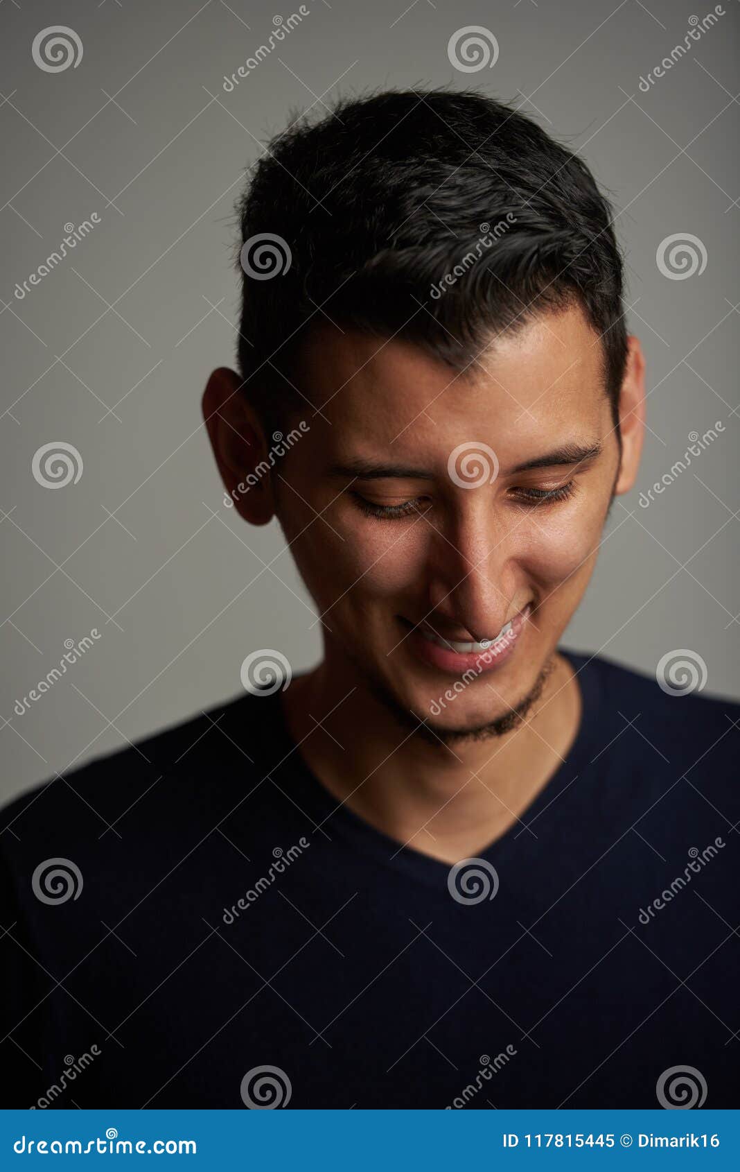 Looking Down Smiling Young Man Stock Image - Image of studio, smiling ...