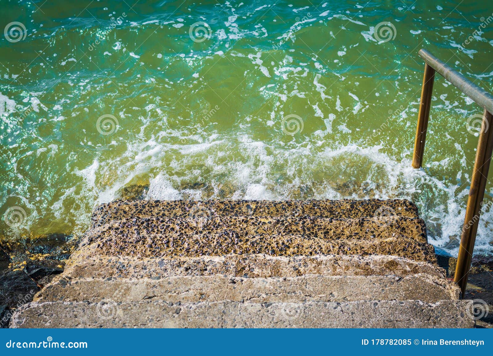 Looking Down the Steps Going into Water As Waves Splash at the Bottom ...
