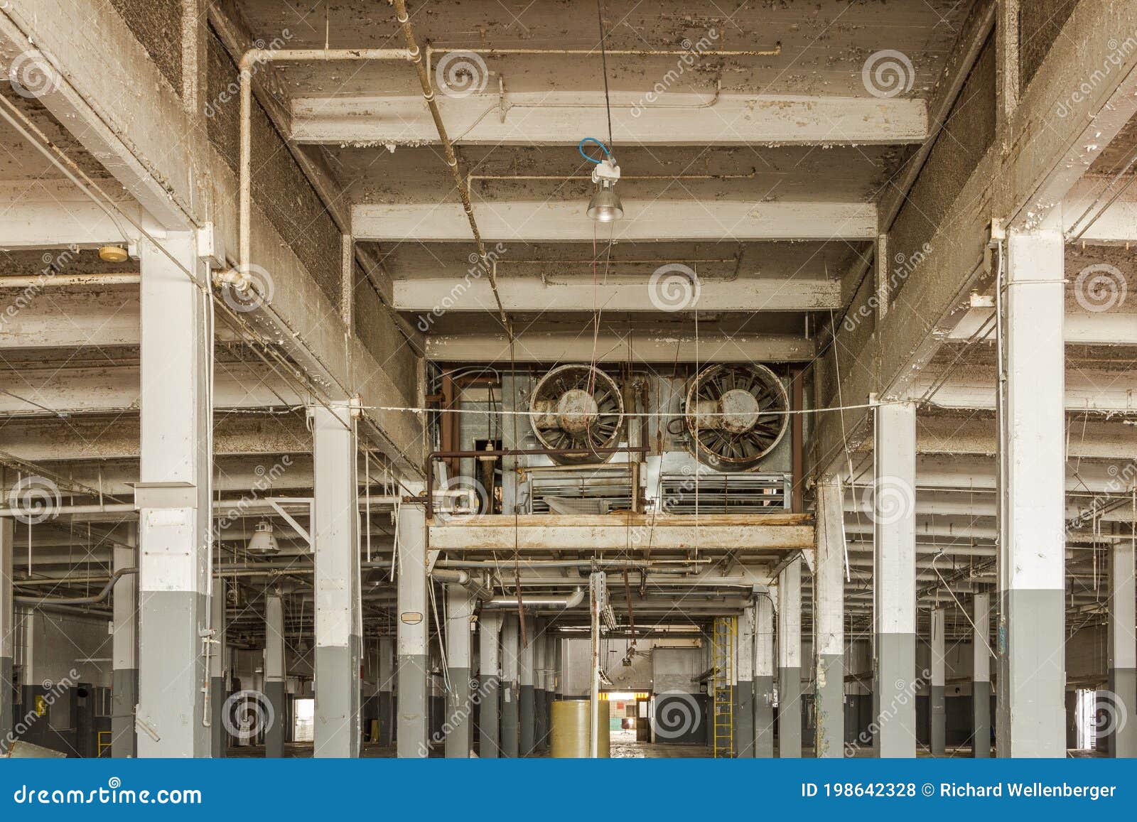 Looking Down between Support Beams in a Large Abandoned Factory Stock ...