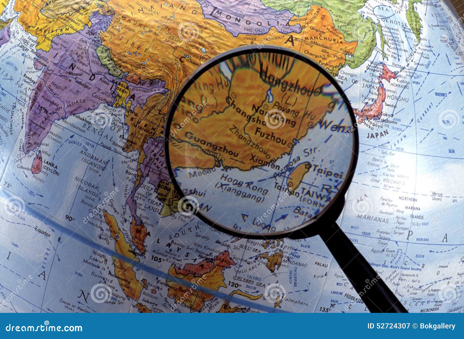 Looking at Globe Using Magnifying Glass (Asia Region) Stock Image ...