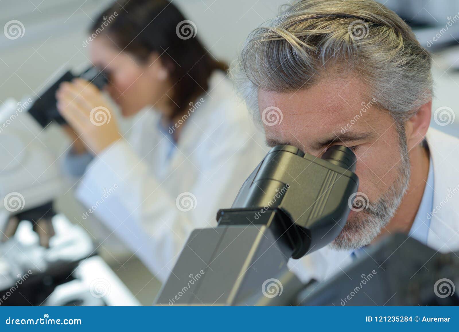 Looking through a Microscope Stock Photo - Image of health, atomic ...