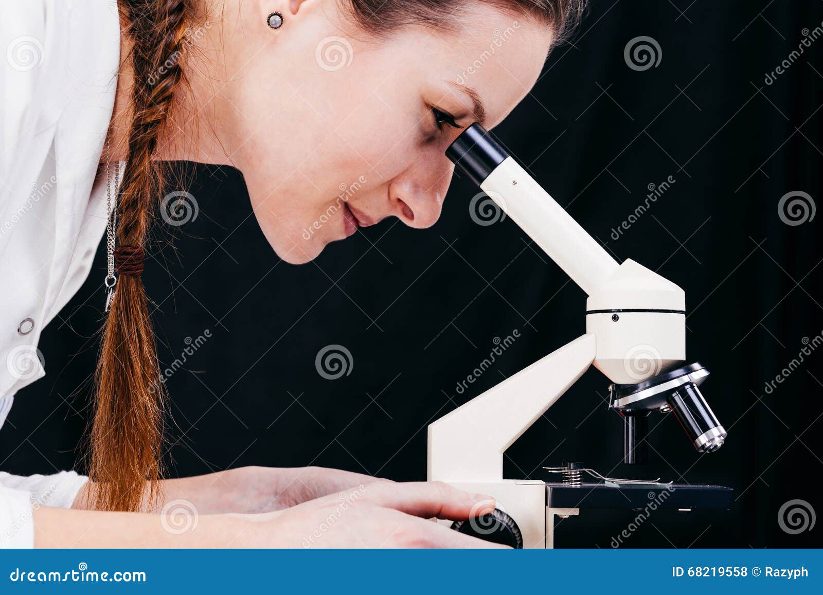 Looking through microscope stock photo. Image of student - 68219558