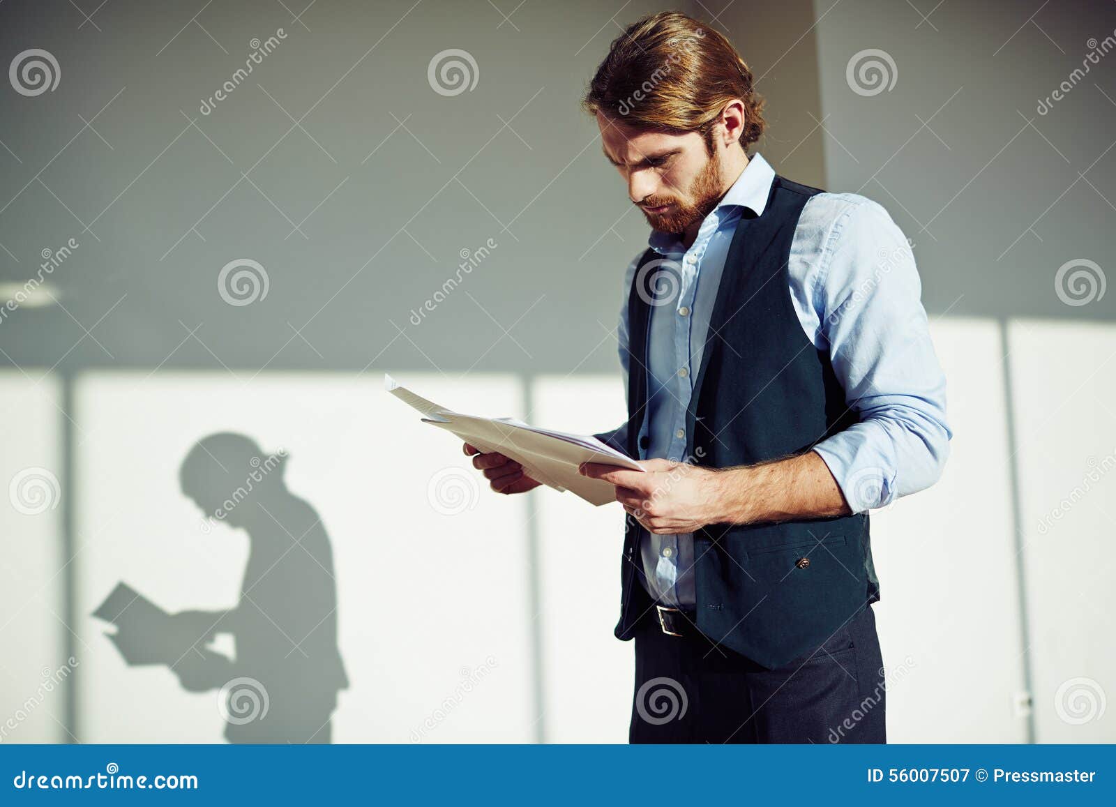 Looking through papers stock image. Image of handsome - 56007507