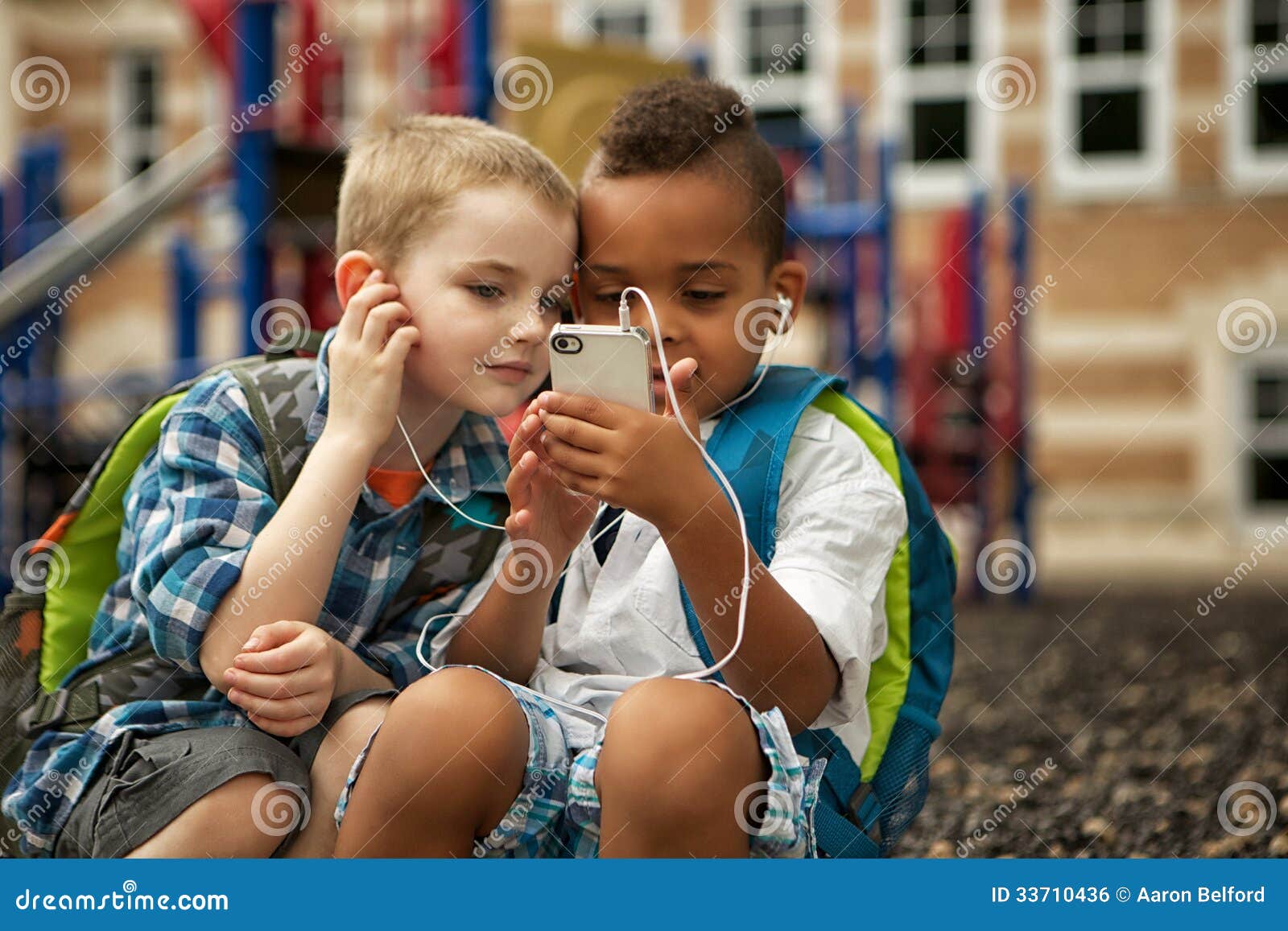 Looking at the Phone stock photo. Image of friends, ethnicity - 33710436