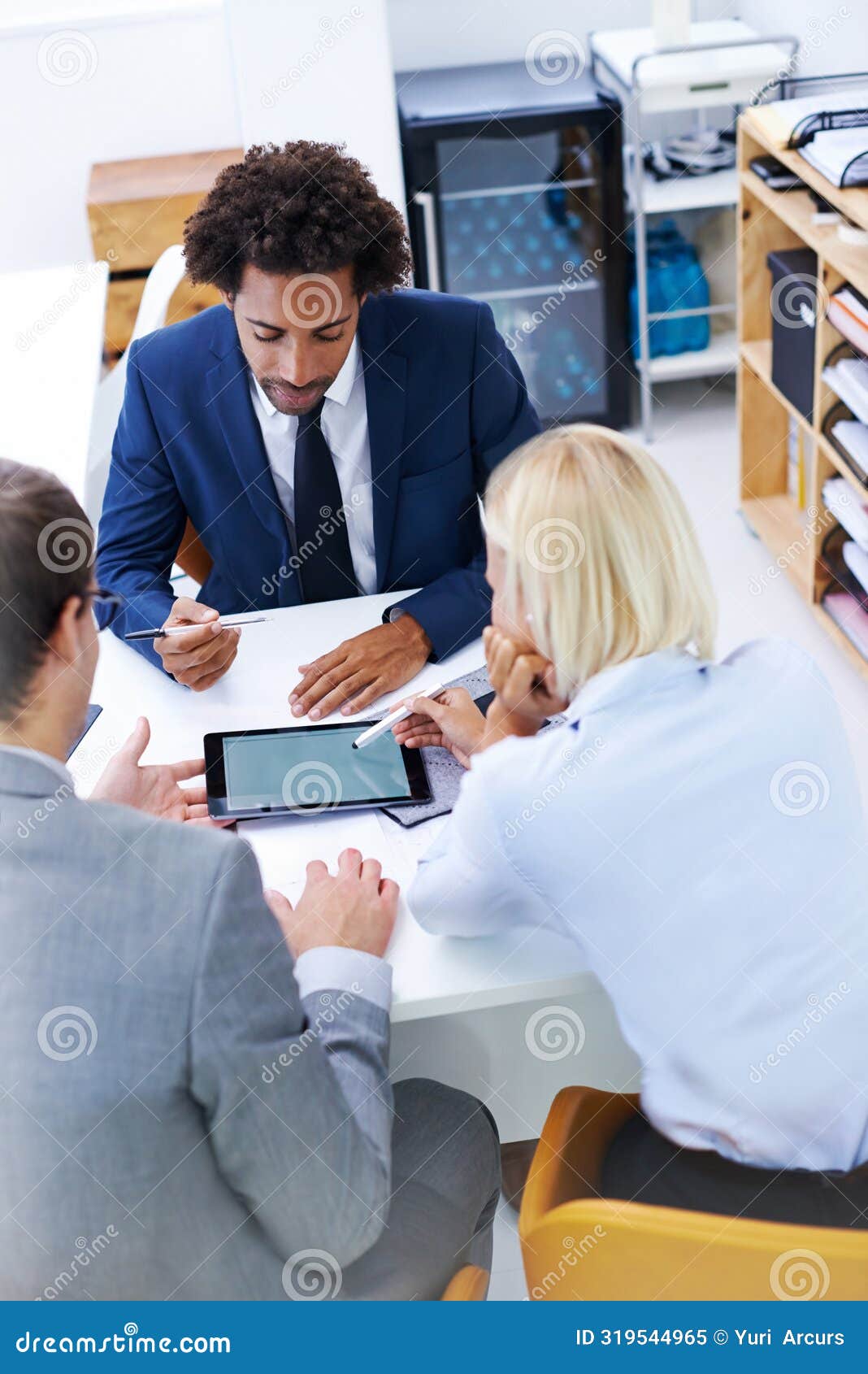 Looking at the Problem Together. Shot of Three Colleagues in an Office ...