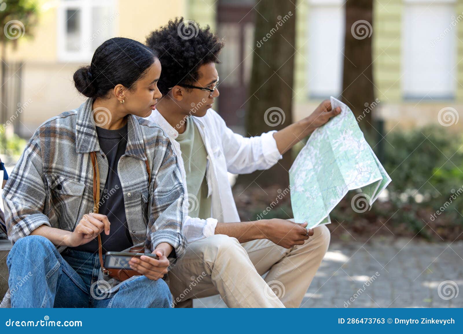 Young People Scrutinizing the Map and Discussing the Route Stock Image ...