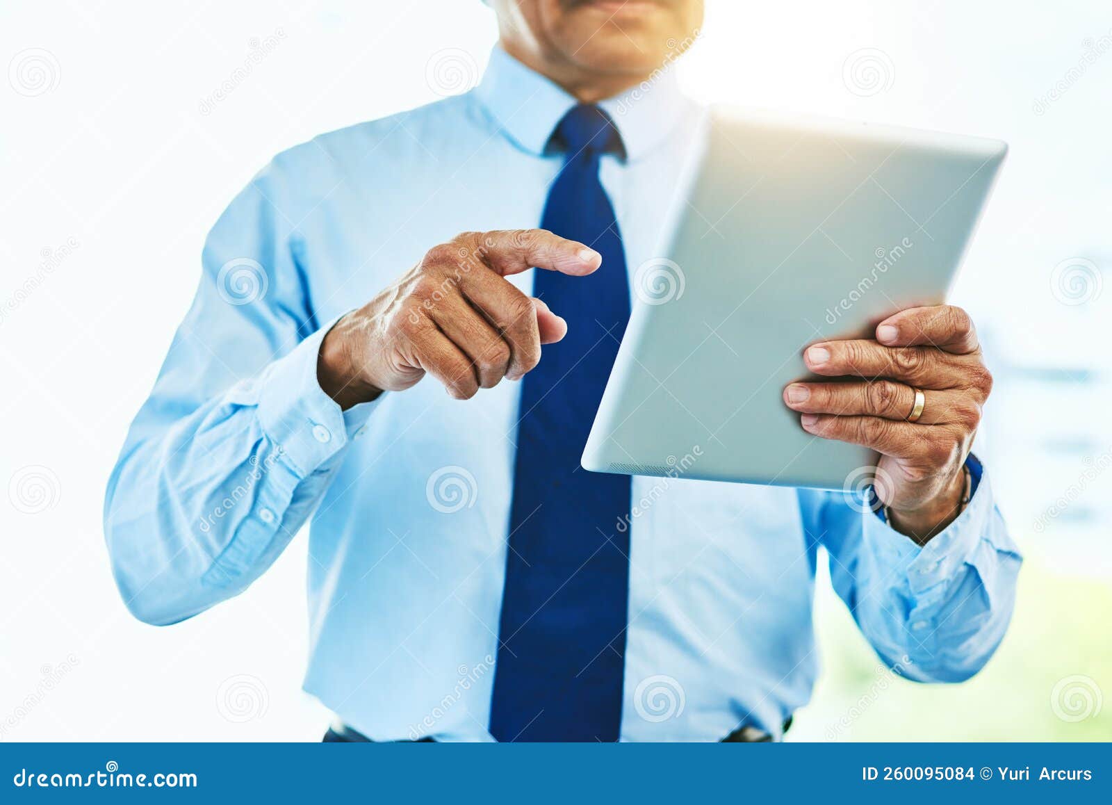 Looking at Some Statistics. an Unrecognizable Man Browsing on a Digital ...