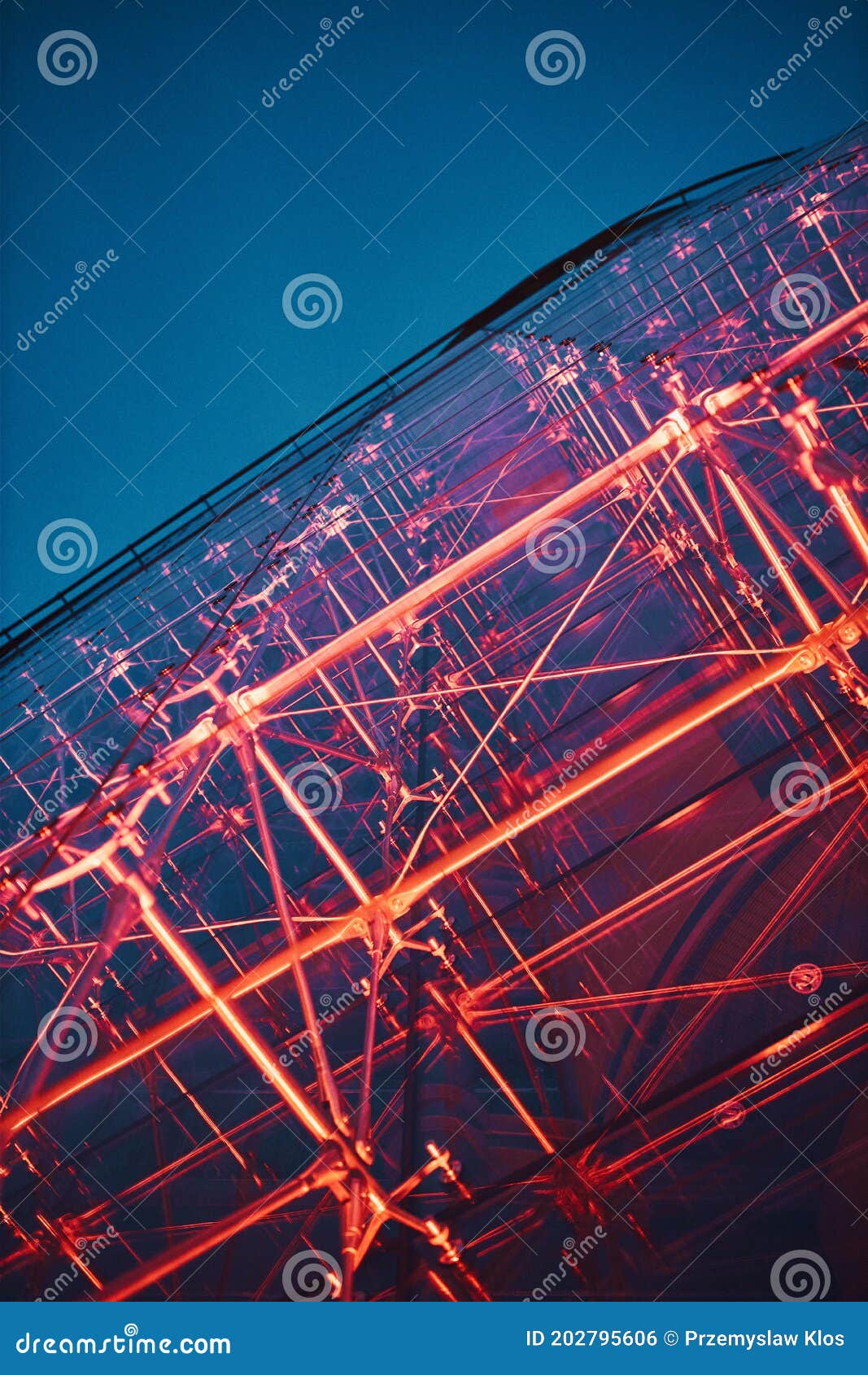 Looking Up at Modern Glass Building Lighted with Red at Night Stock ...