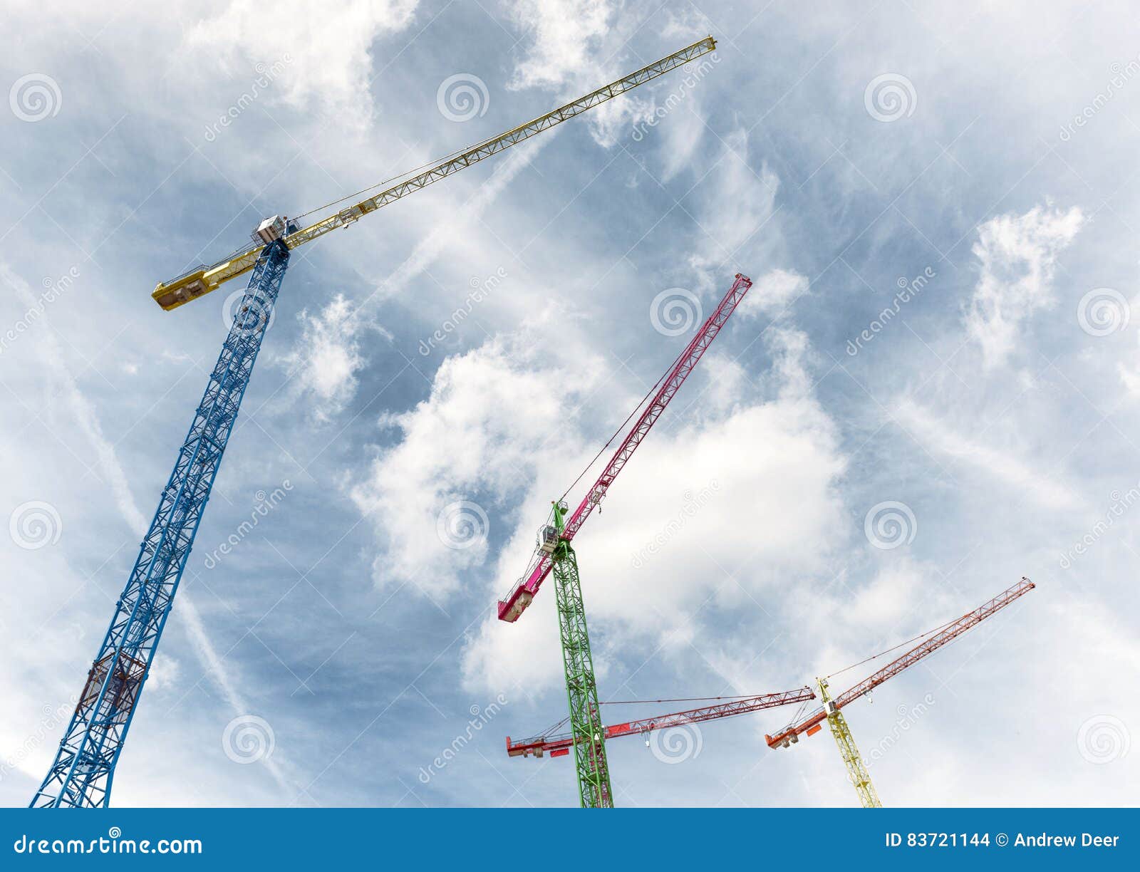 Looking Up at Three Colorful Cranes Stock Photo - Image of trails ...