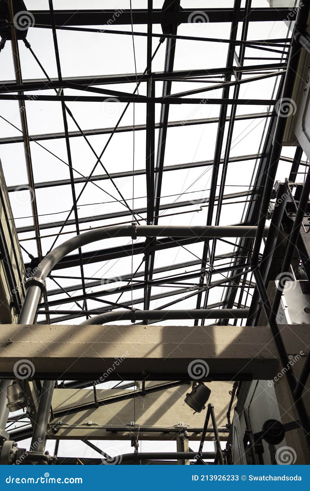 Looking Up View at Large Window Paneled Ceiling and Pipes from Inside ...