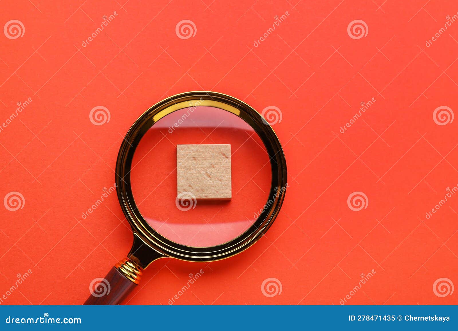 Looking at Wooden Cube through Magnifying Glass on Red Background, Top ...