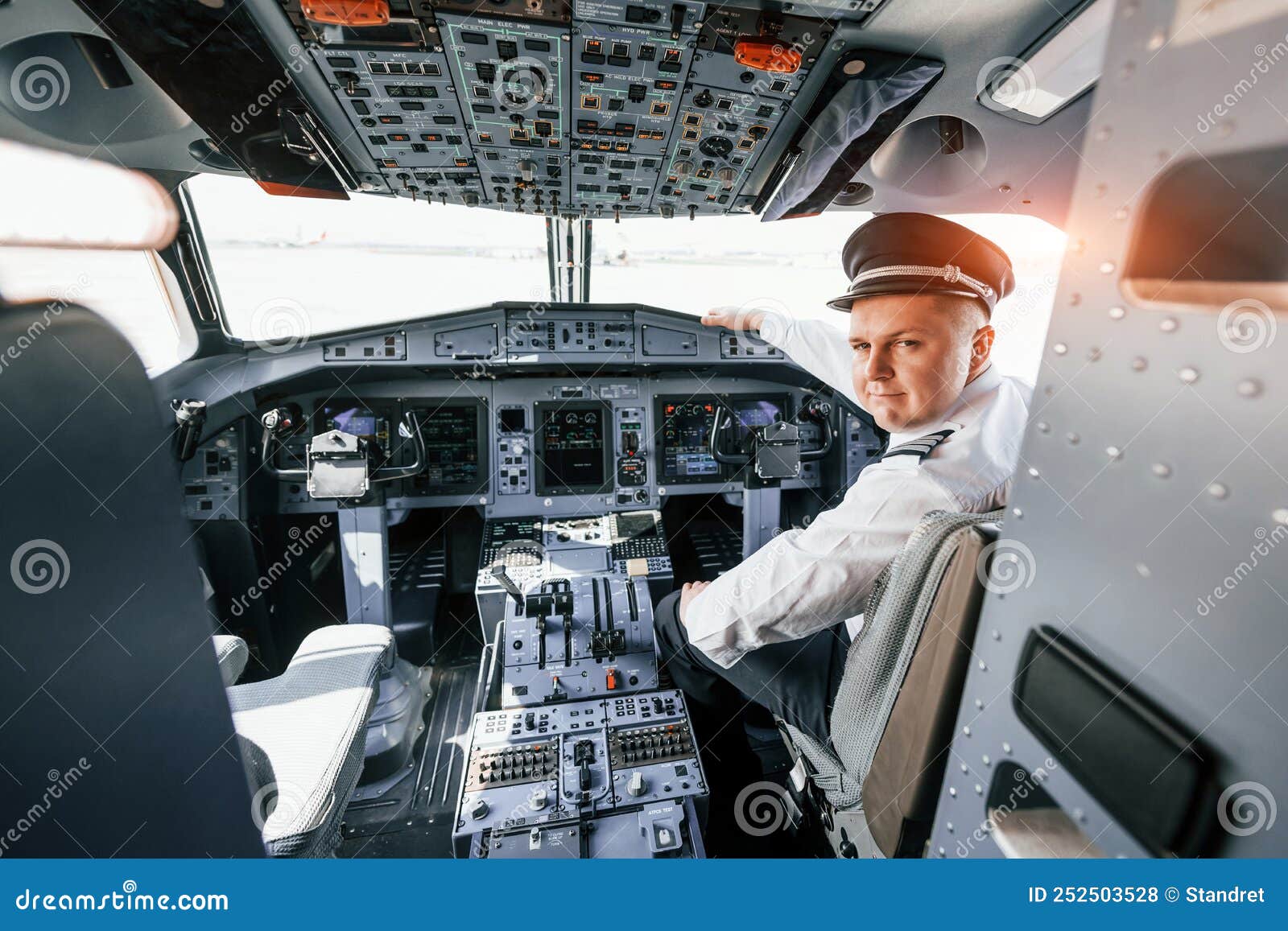 Looks Behind. Pilot on the Work in the Passenger Airplane Stock Photo ...