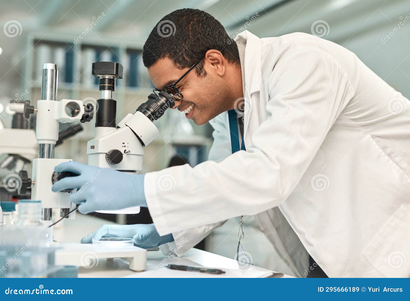 This Looks Interesting. a Young Scientist Using a Microscope in a Lab ...