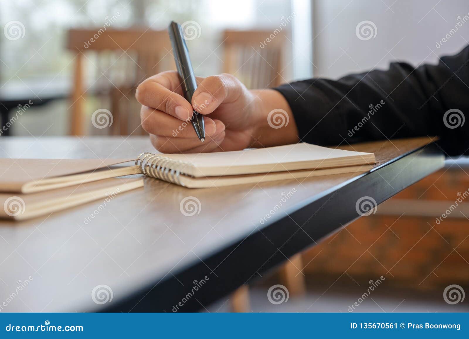 A Hand Writing on Blank Notebook on Table in Cafe Stock Image - Image ...