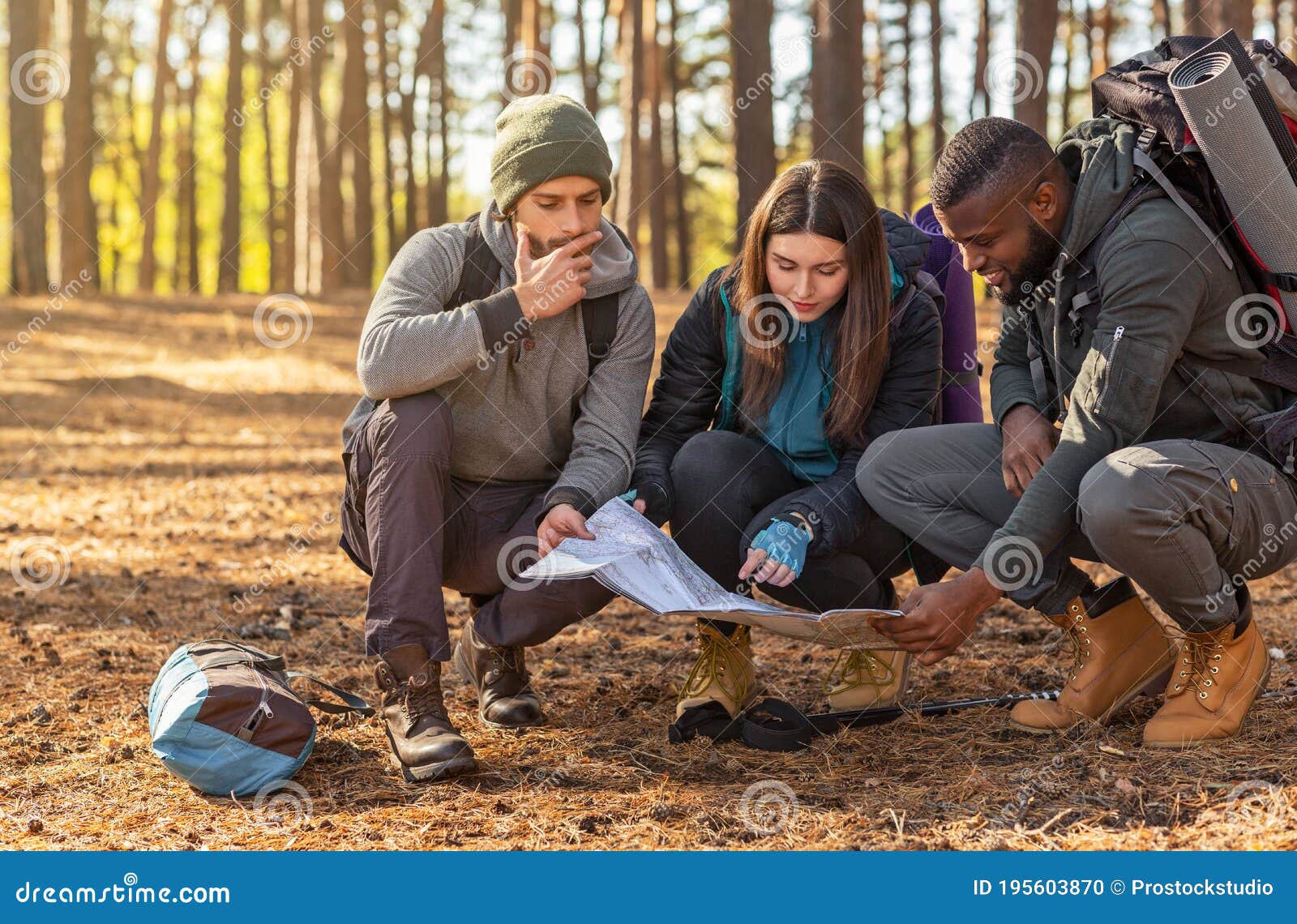 Lost Backpackers Looking for Location, Using Map Stock Photo - Image of ...