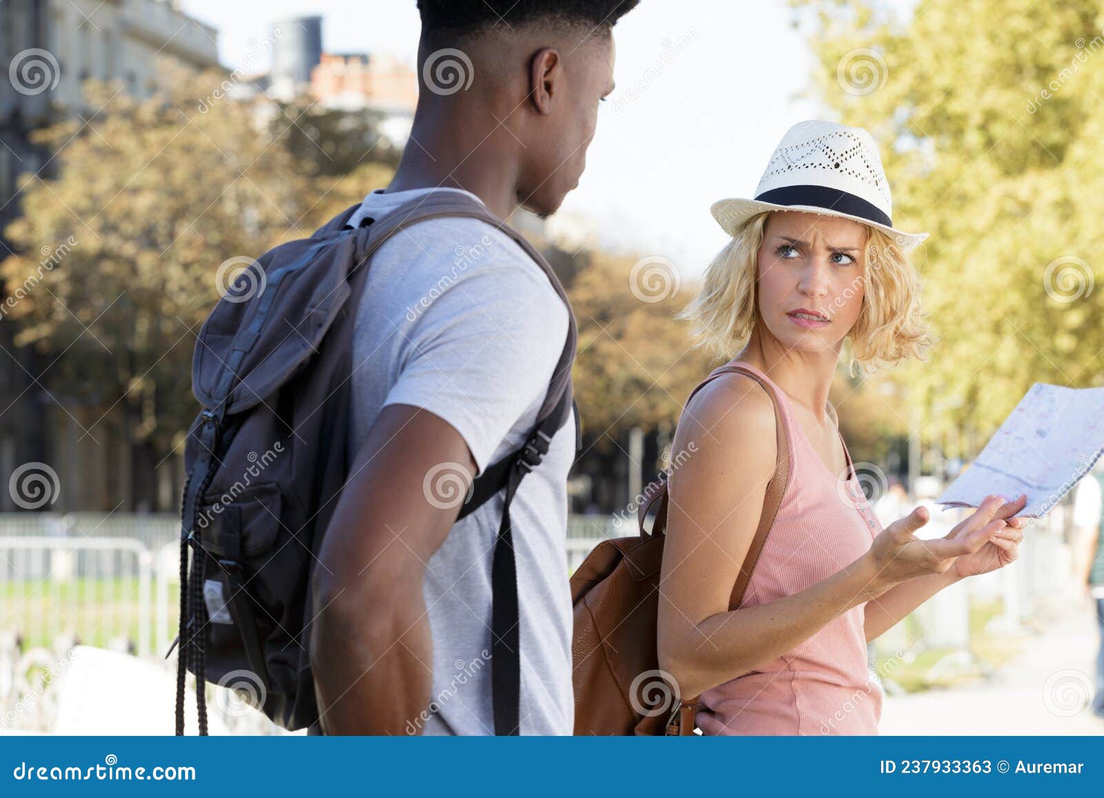Lost and Confused Mixed Couple Looking Over Map Outside Stock Image ...