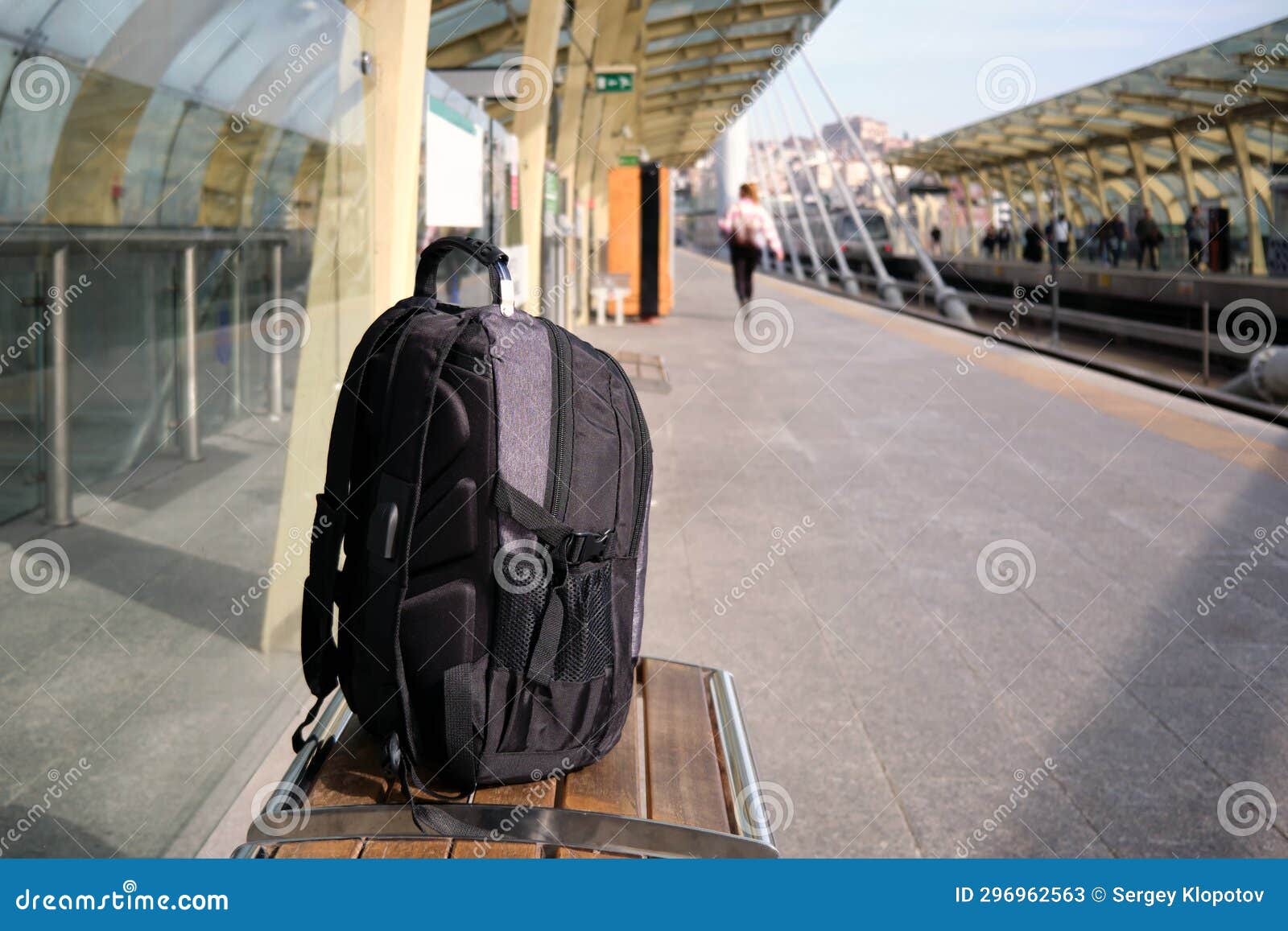 A Lost or Forgotten Backpack on a Bench on an Open Platform of a City ...