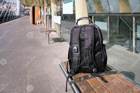 A Lost or Forgotten Backpack on a Bench on an Open Platform of a City ...