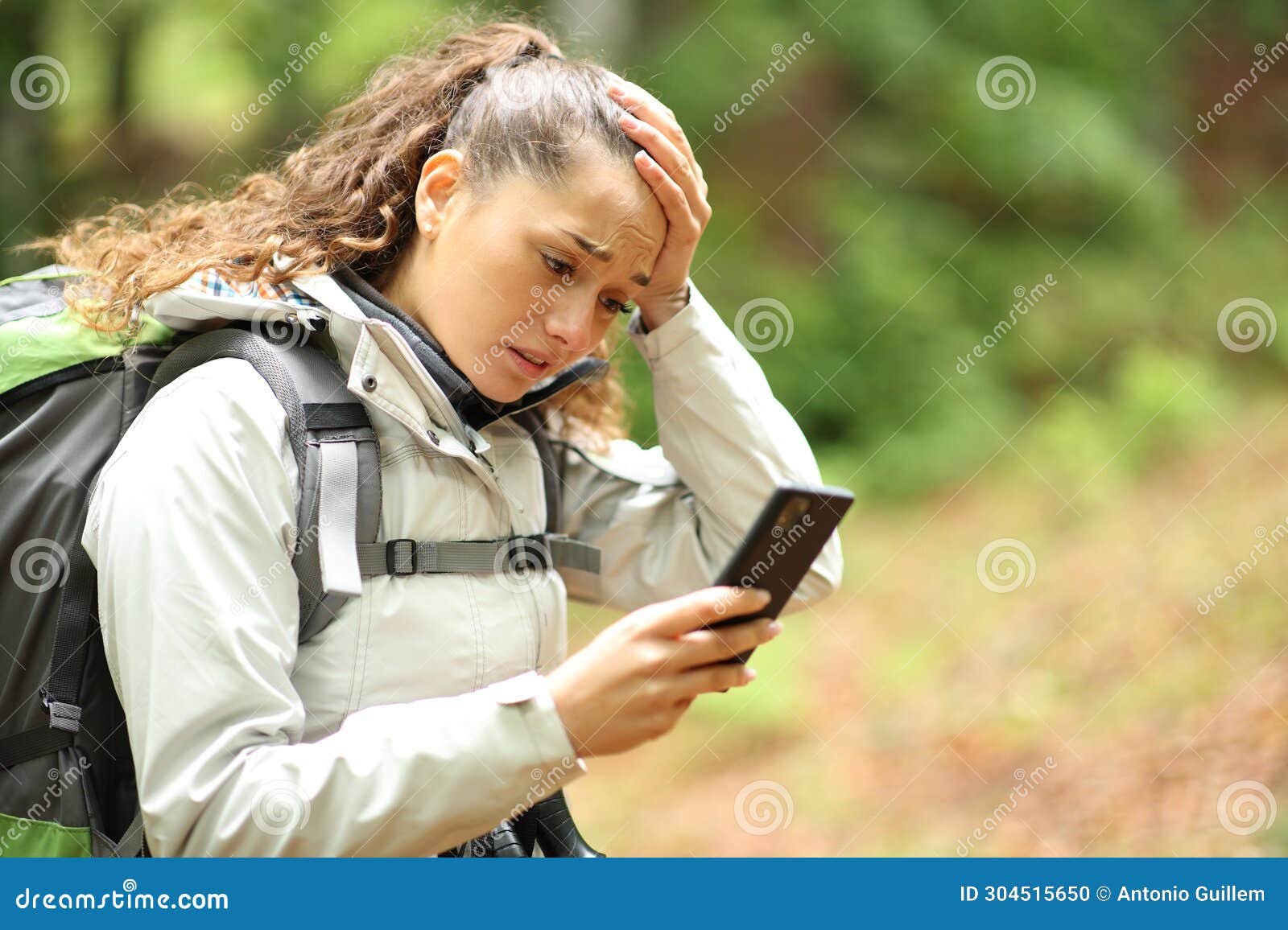 Lost Hiker Complaining Checking Cell Phone in a Forest Stock Photo ...