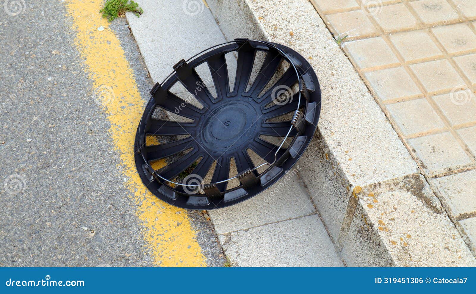 Lost Hubcap from a Car Wheel Lies on Side of the Road Stock Photo ...