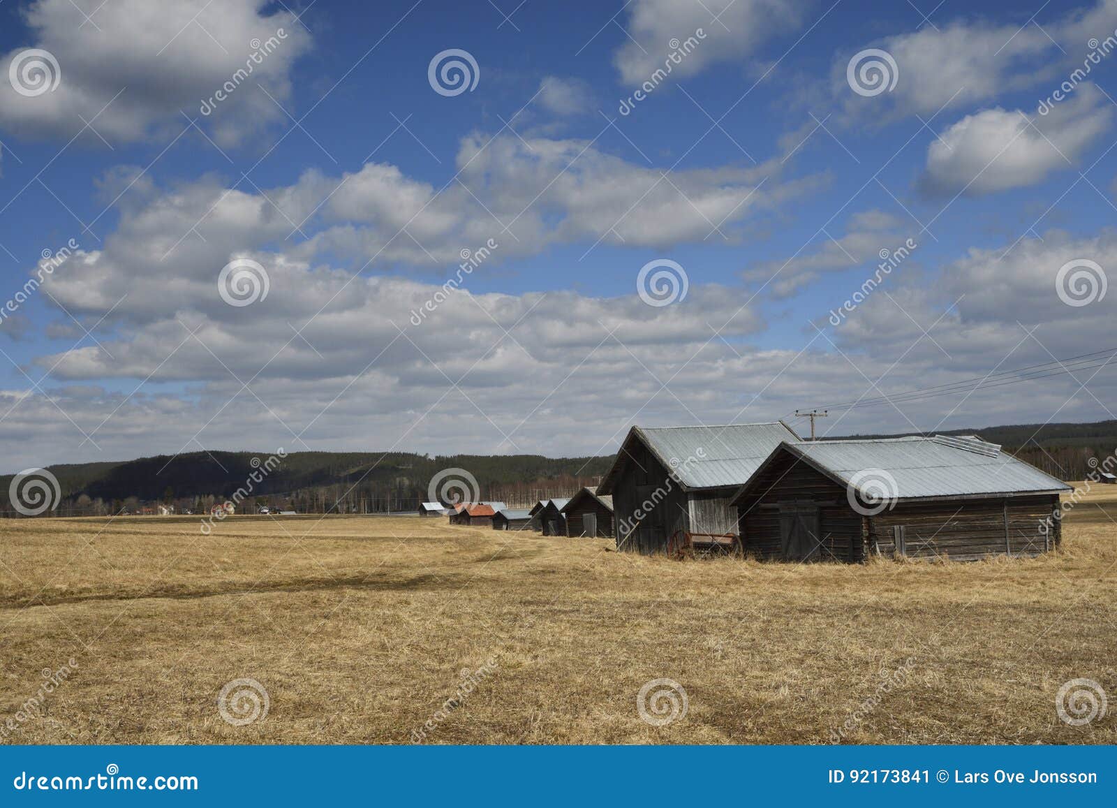 Lot of Barns Standing in a Row on a Field Stock Image - Image of ...