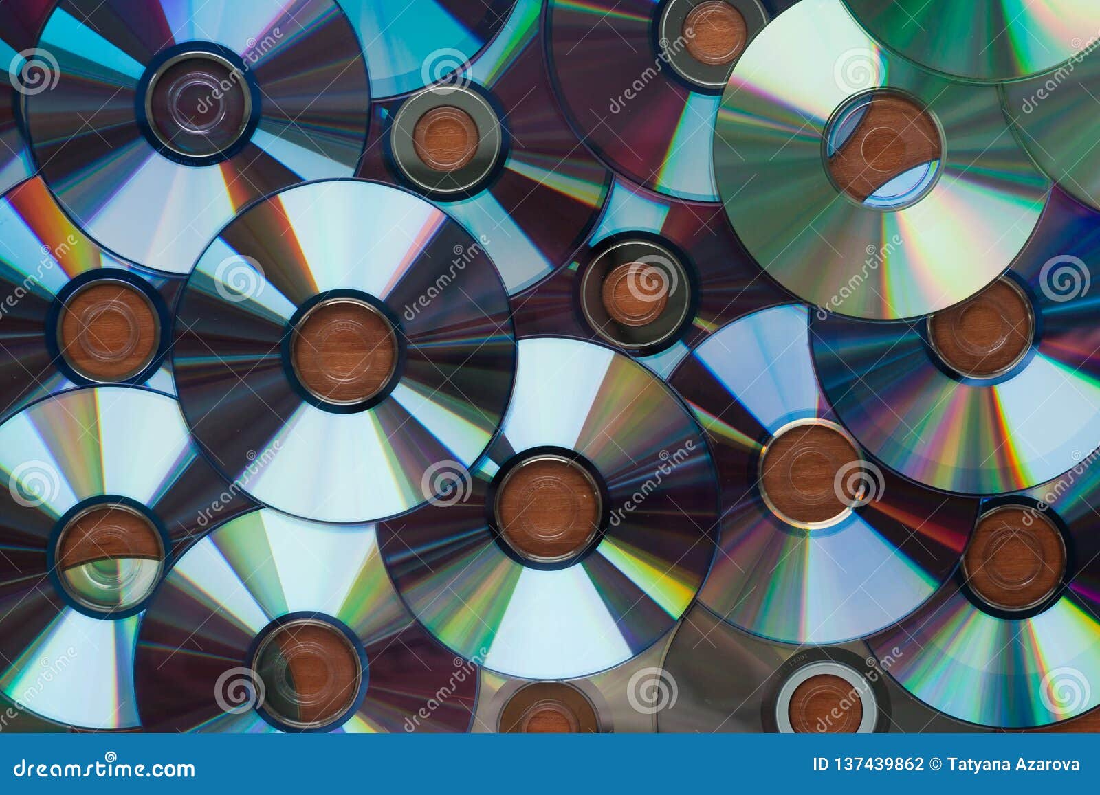 A Lot of Computer Cd Disks Reflecting on a Wooden Surface, Background ...