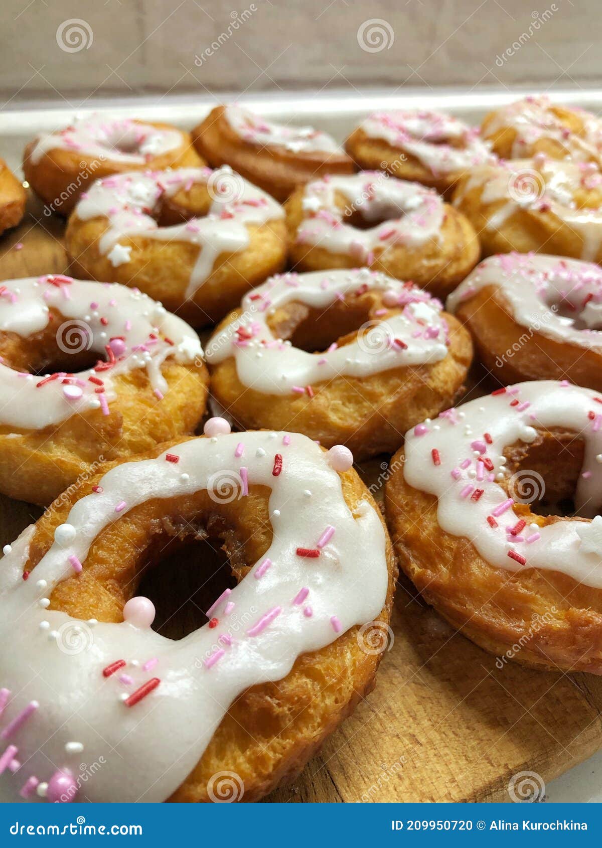 A Lot of Donuts in Icing Sugar and Icing. Vertical Photo Stock Photo ...