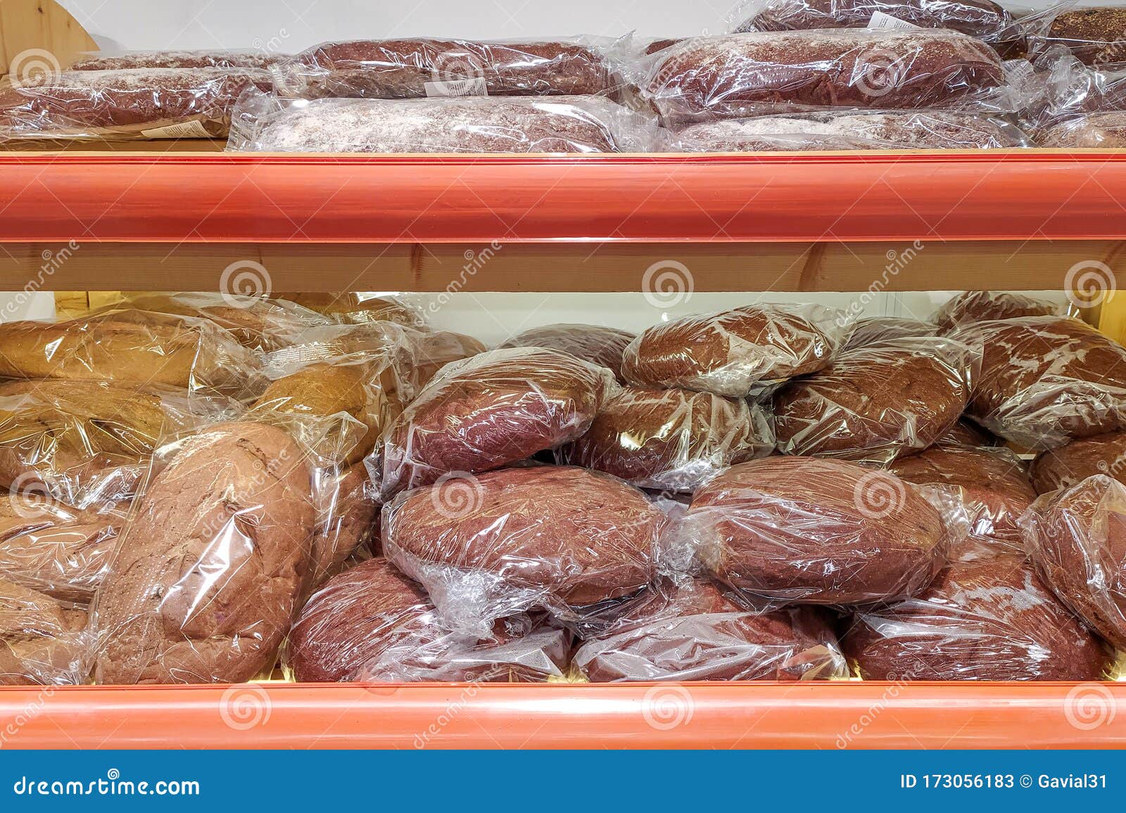 A Lot of Loaves of Bread in Packaging on the Counter in the Store ...