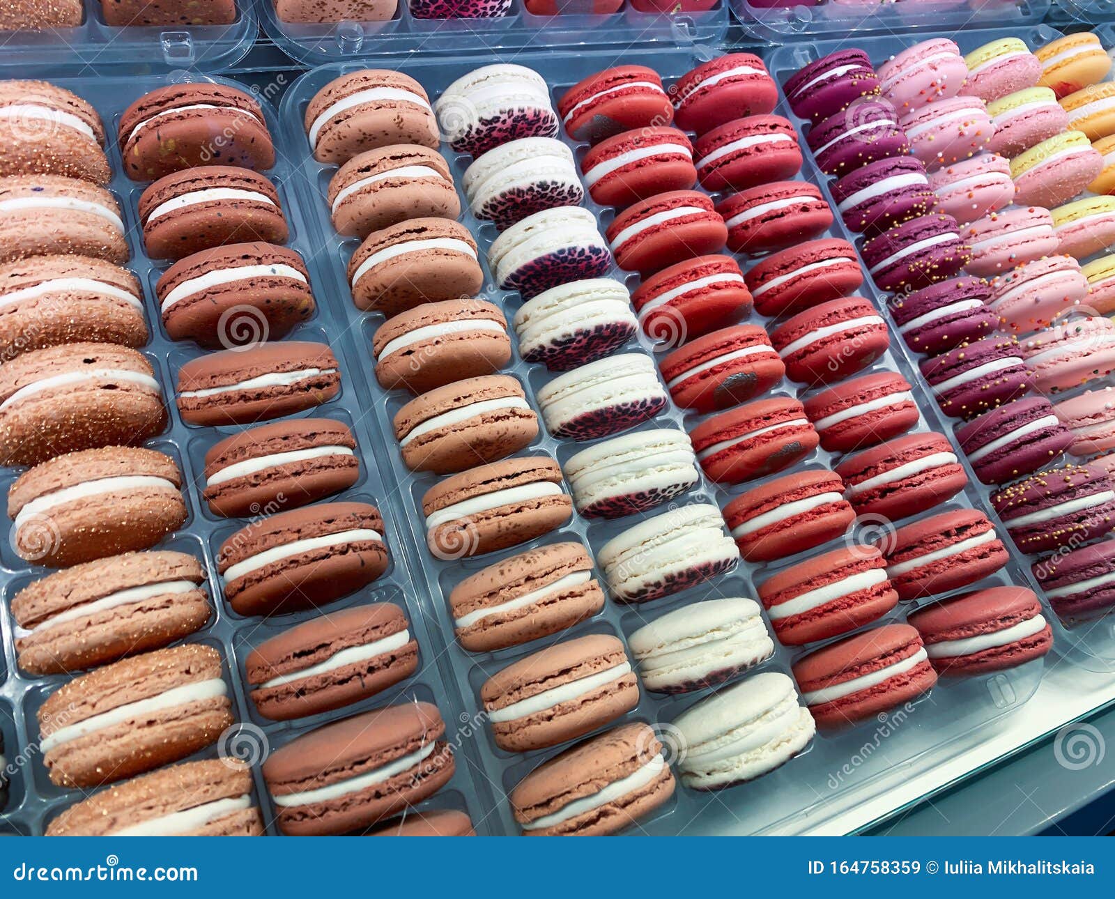 A Lot of Macarones, Macaroons in Brown Colors Lying in a Row in a Candy ...