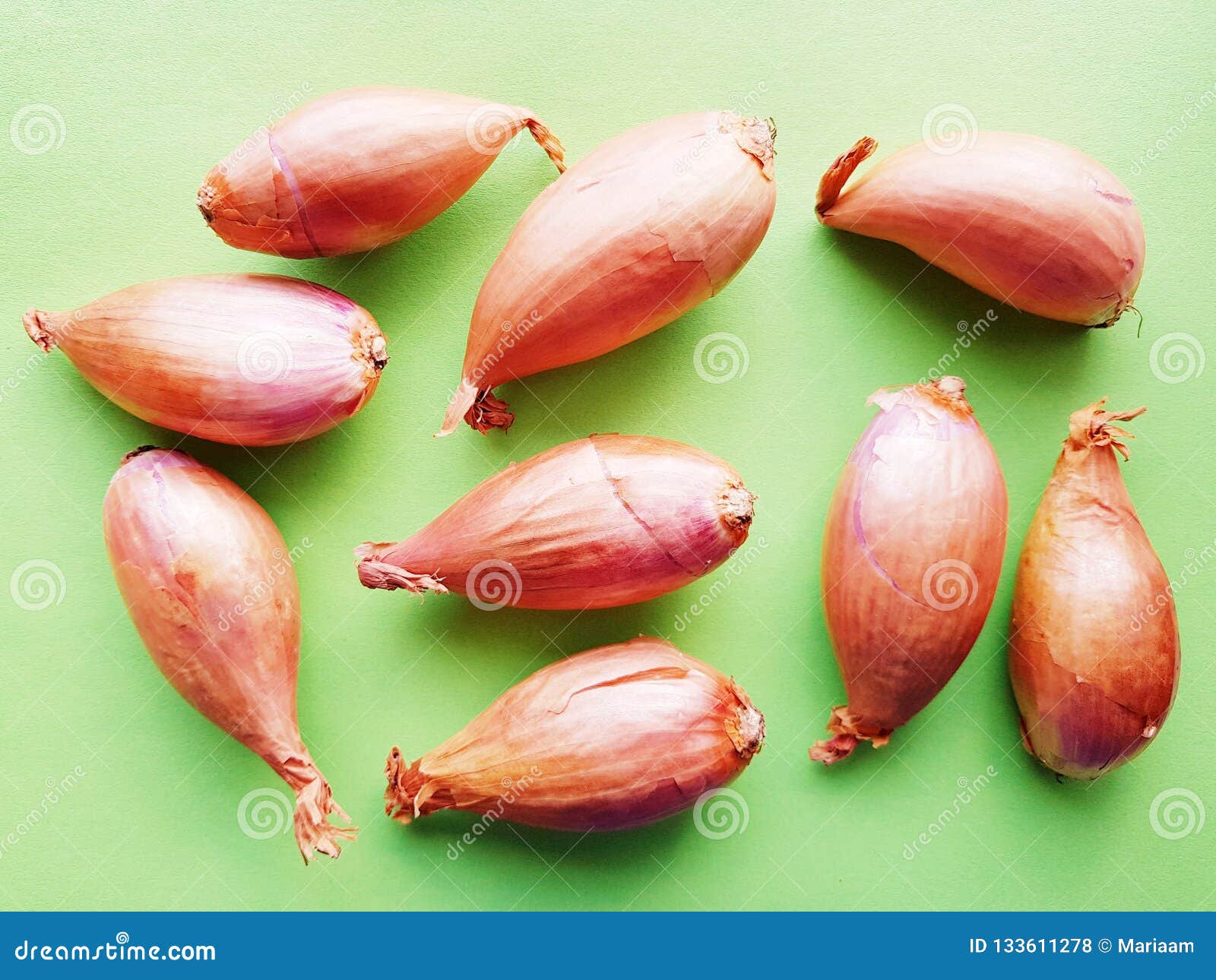 A Lot Of Onions Over Green Table. Closeup Of Onions. Stock Photo ...
