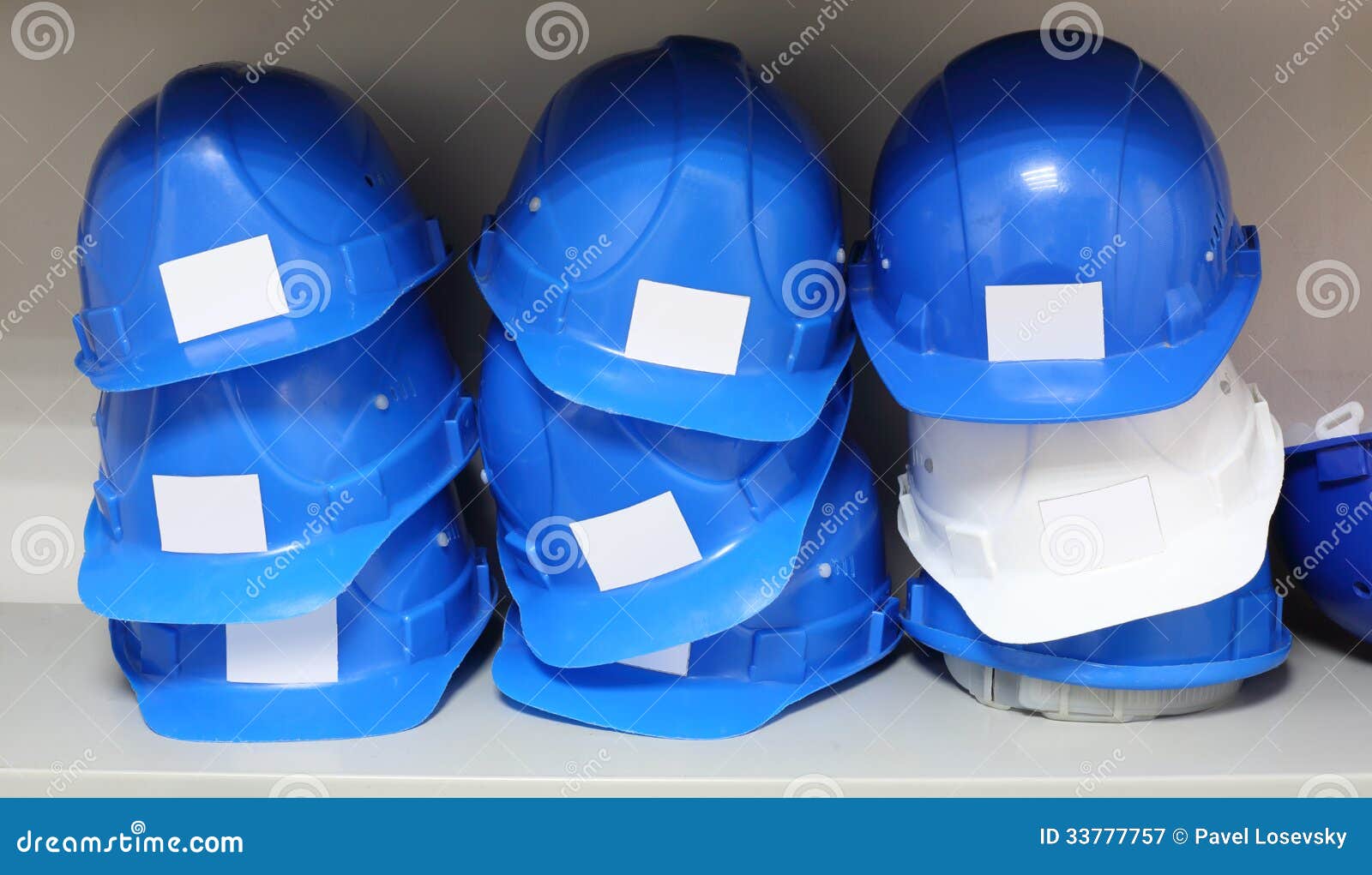 Lots of Blue and One White Construction Helmets Stock Image - Image of ...