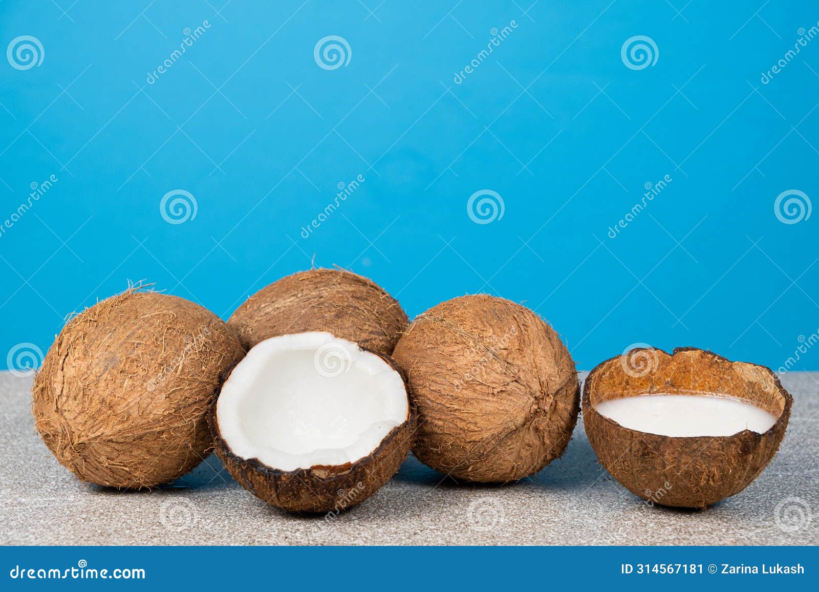 Lots of Coconuts on Blue Background, Coconut Milk in Shell, Space for ...