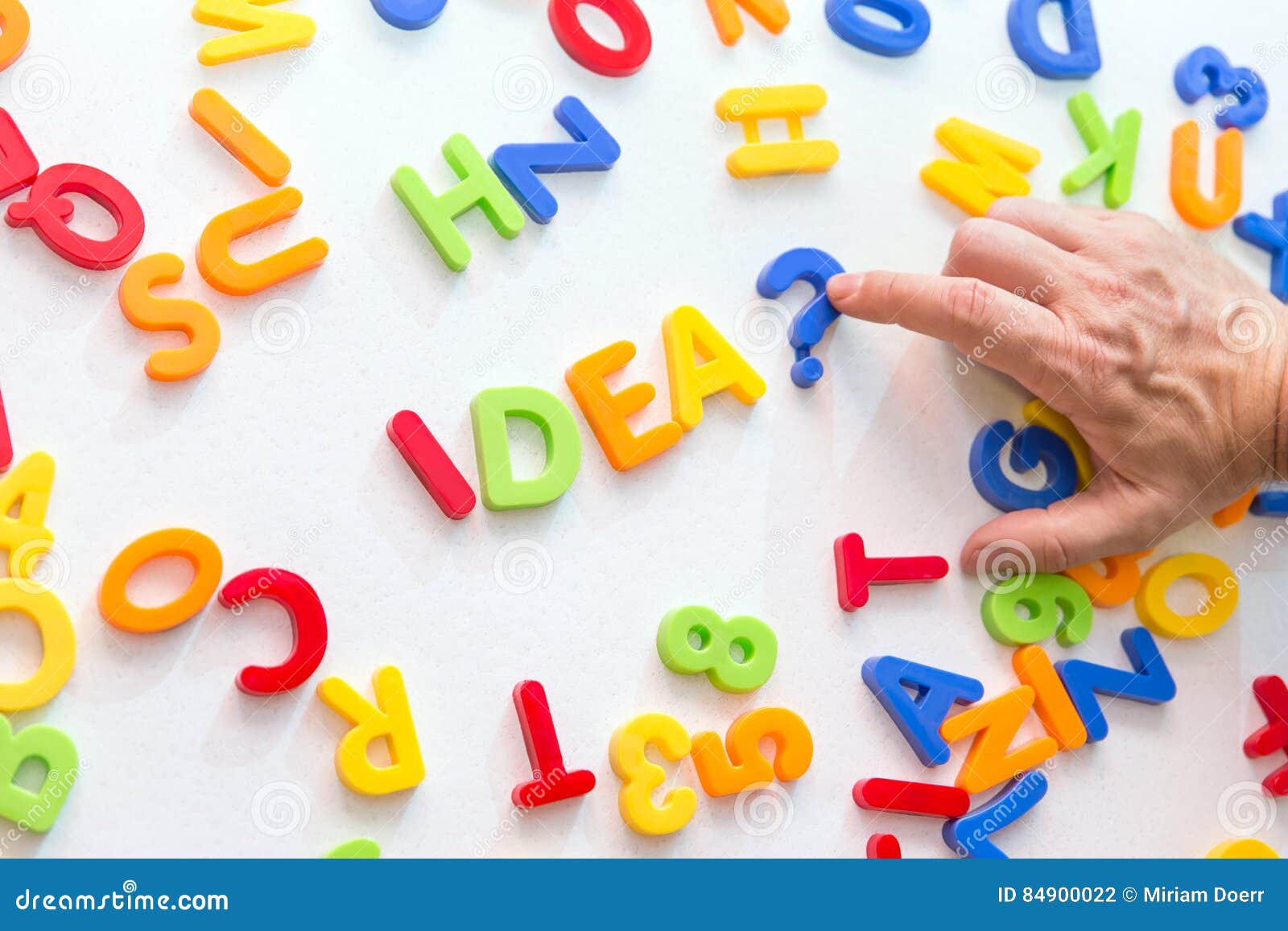 Lots of Colorful Letters on a Table, Man Forming the Word Idea Stock ...